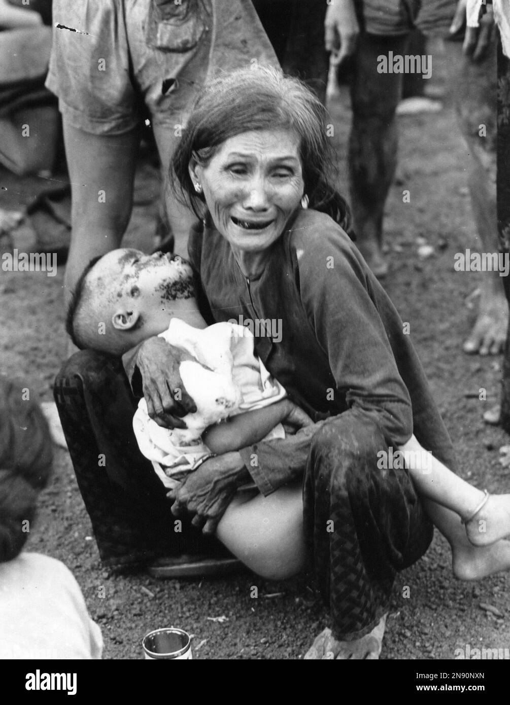 A weeping mother holds her child, killed in an air strike that preceded ...