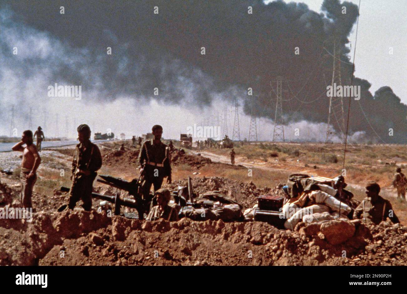 Iraqi soldiers wait by a well-hidden tank in a roadside bunker beside ...