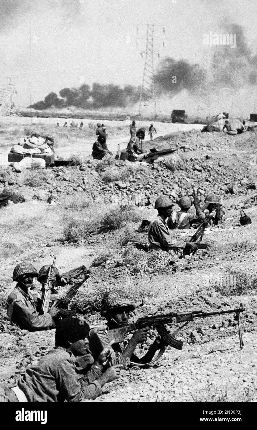 Iraqi soldiers in foxholes near their pontoon bridge crossing over the ...