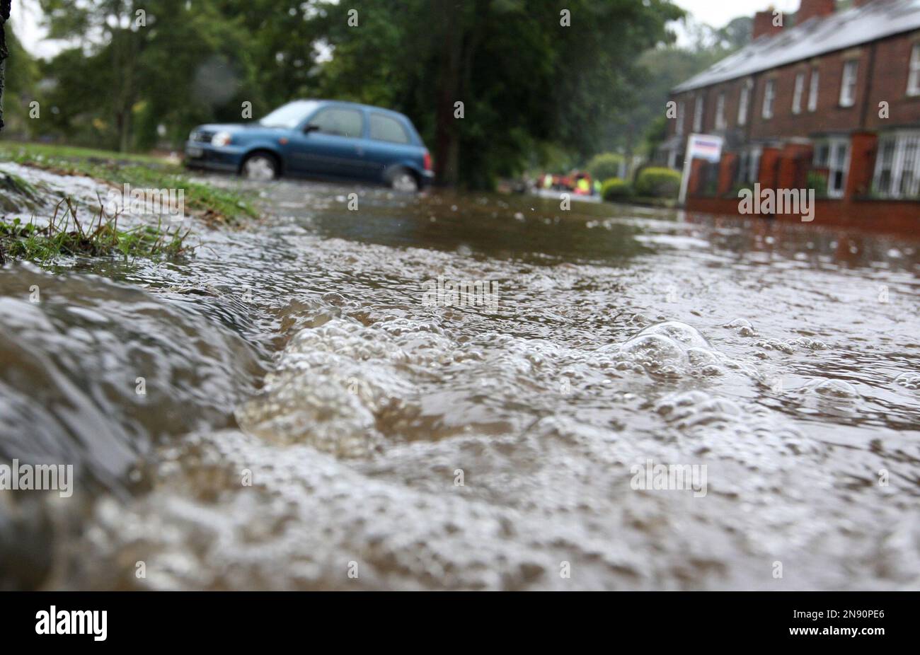 Flood waters pours into a residential street after the River Wansbeck ...