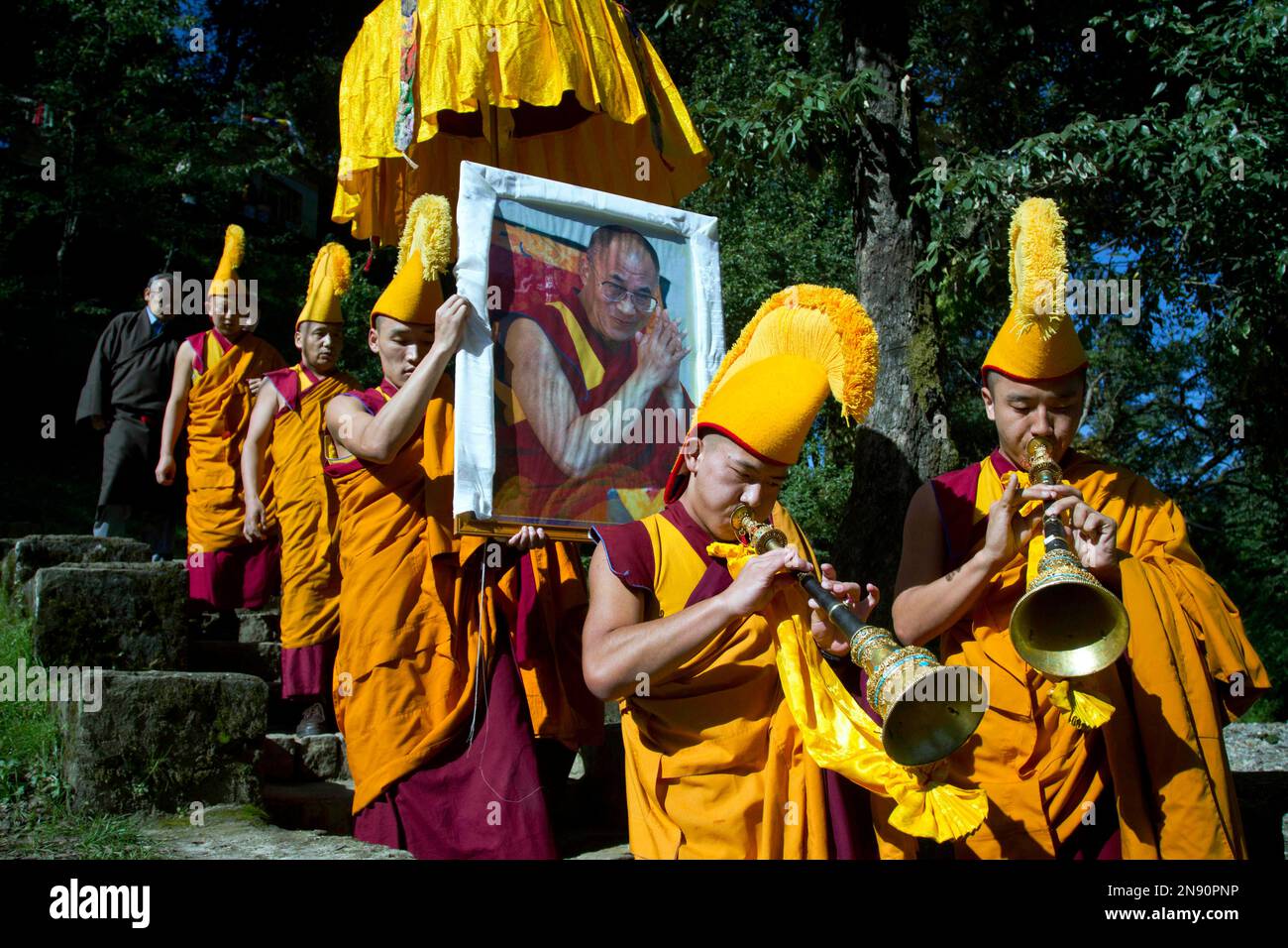 Exiled Tibetan Buddhist monks carry a portrait of spiritual leader the ...