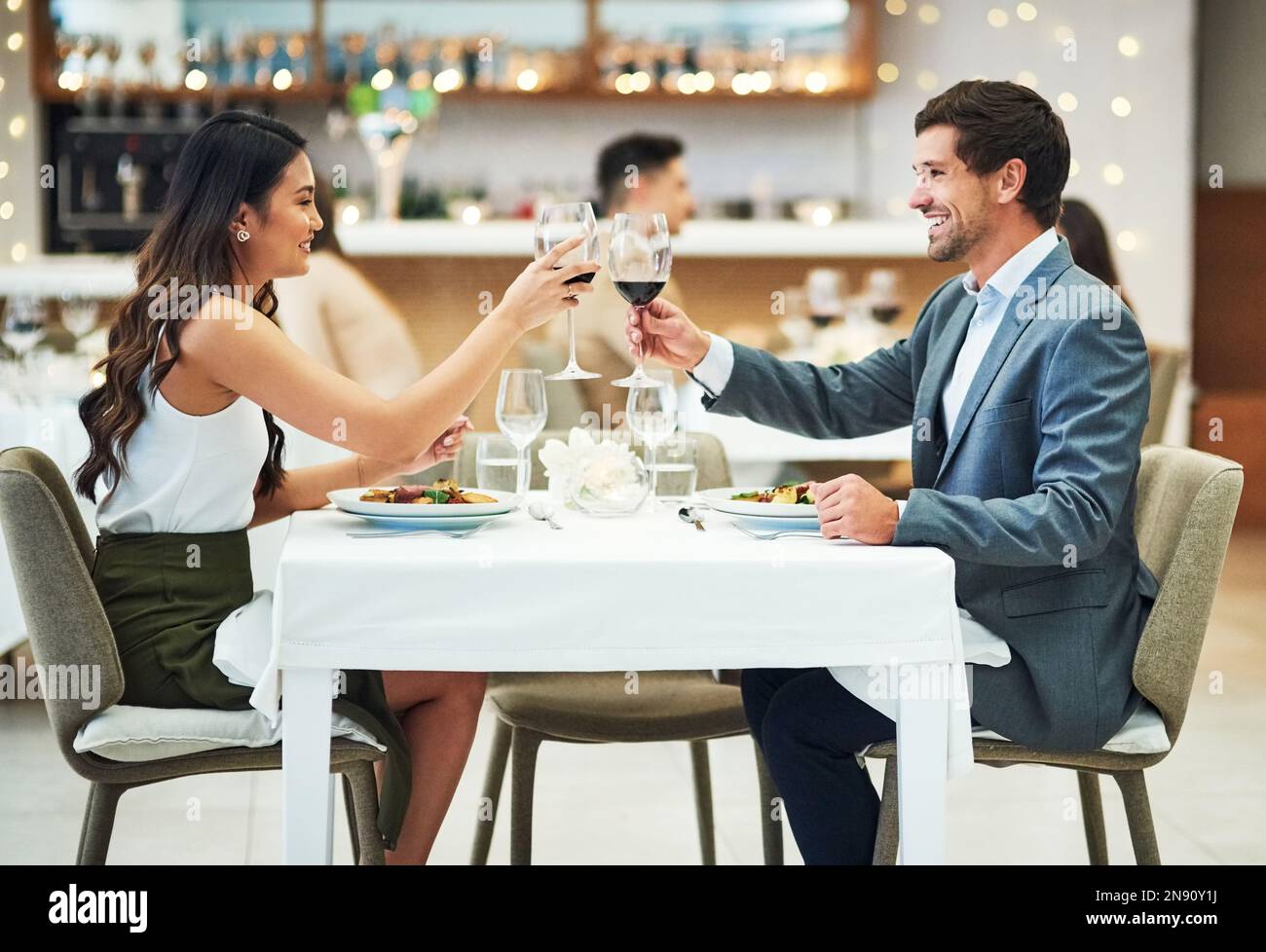 Love, wine and couple toast in restaurant for romantic dinner ...