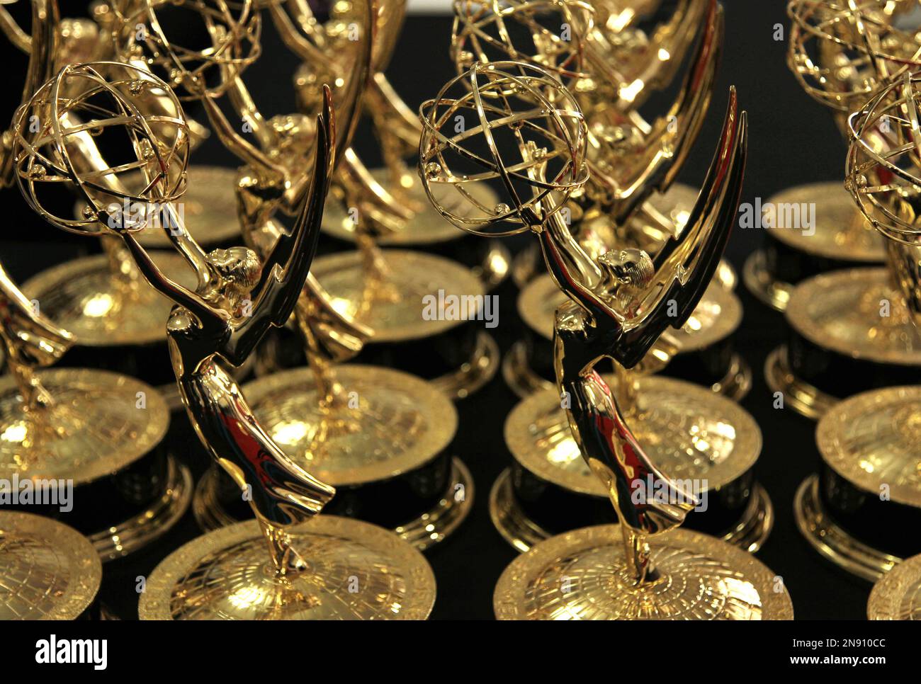 Statues of the 64th Emmy awards are displayed on a table backstage at ...