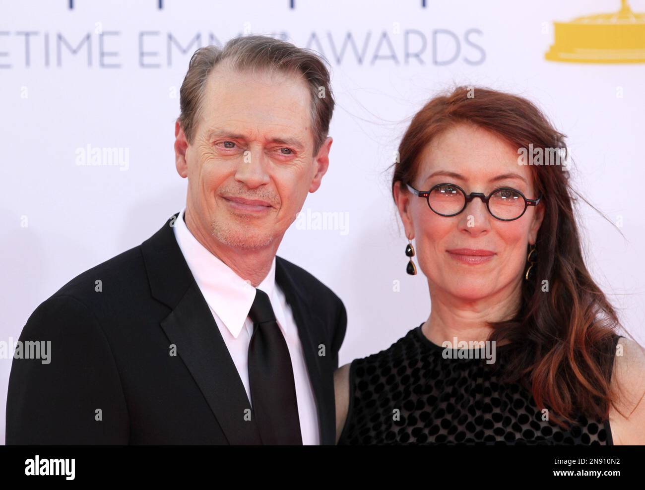 Steve Buscemi, left, and Jo Andres arrive at the 64th Primetime Emmy ...
