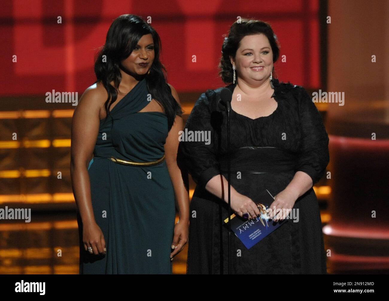 Mindy Kaling, left, and Melissa McCarthy present an award onstage at ...