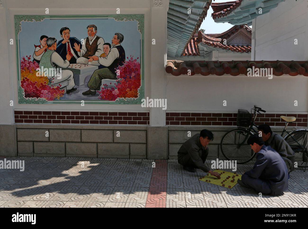 Three North Korean men play chess at a Folk Street in Sariwon, North ...