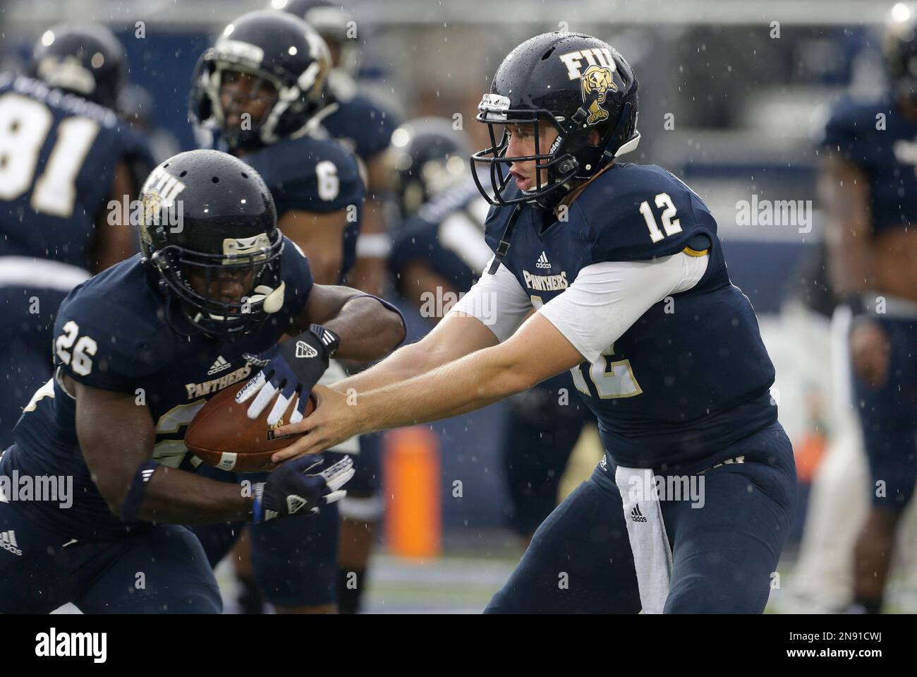 Florida International quarterback Jake Medlock (12) hands off the ...