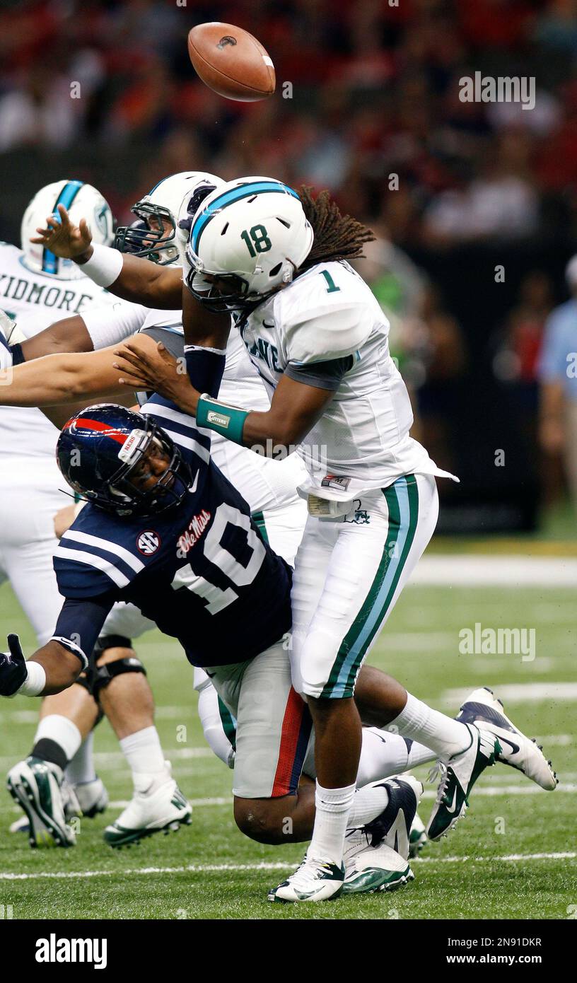 Mississippi defensive end C.J. Johnson (10) knocks the ball from Tulane ...