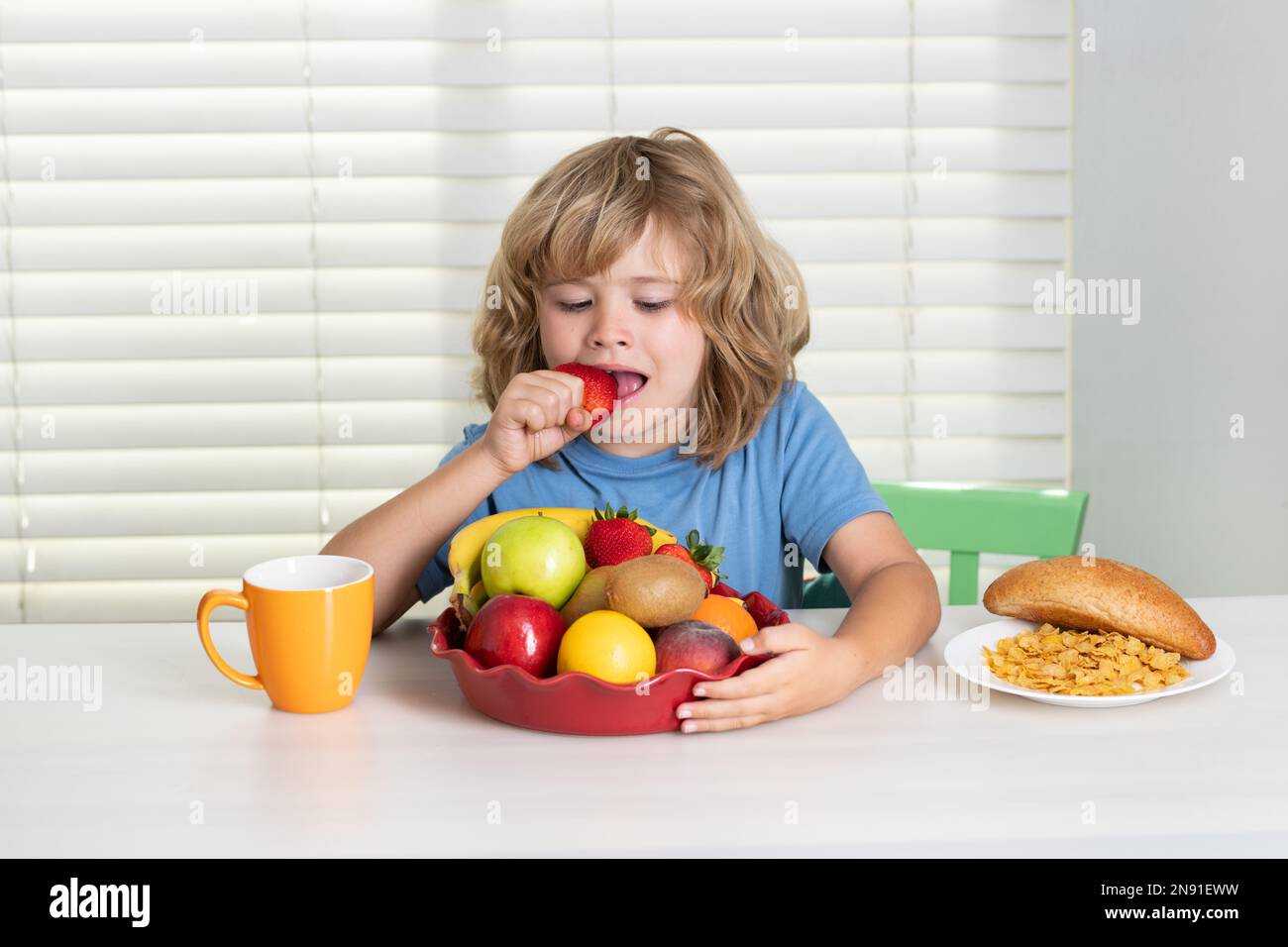 Child eats strawberry, organic fruits. Portrait of preteen child eat ...
