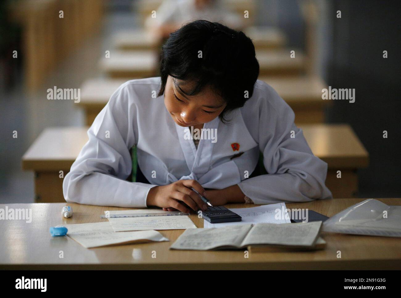 A North Korean student uses a caliculator at the Kim Chaek University ...