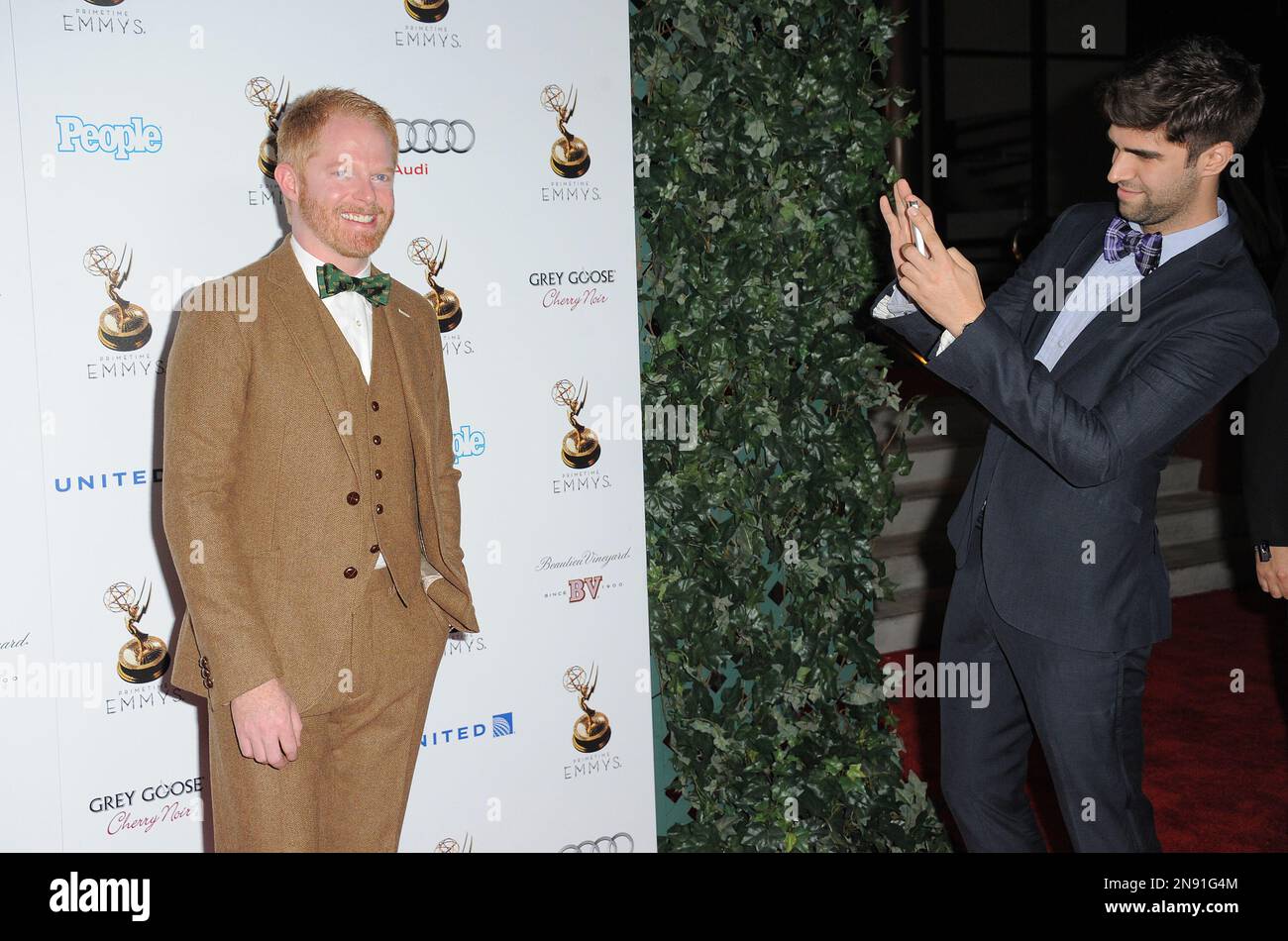 Justin Mikita, right, takes pictures of Jesse Tyler Ferguson at the ...