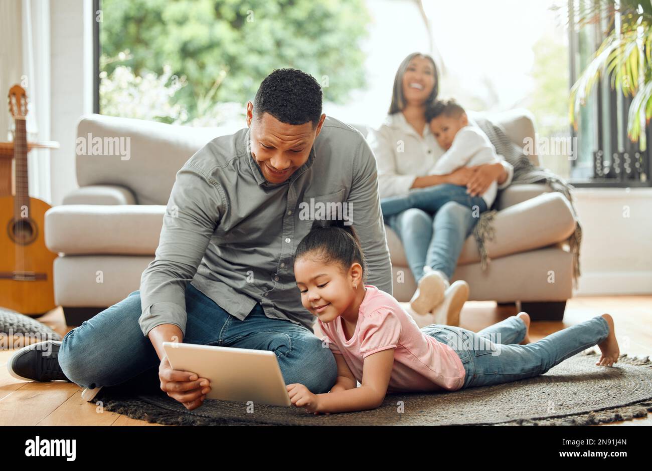 He has to learn to wait his turn. a father and daughter using a digital ...