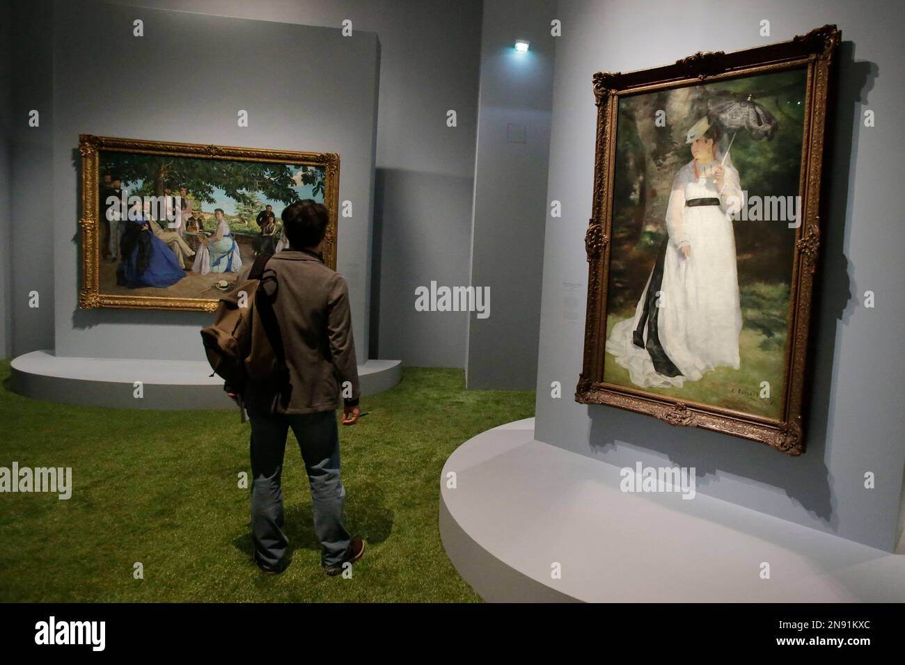 A journalist walks past during the press day of the Impressionism ...