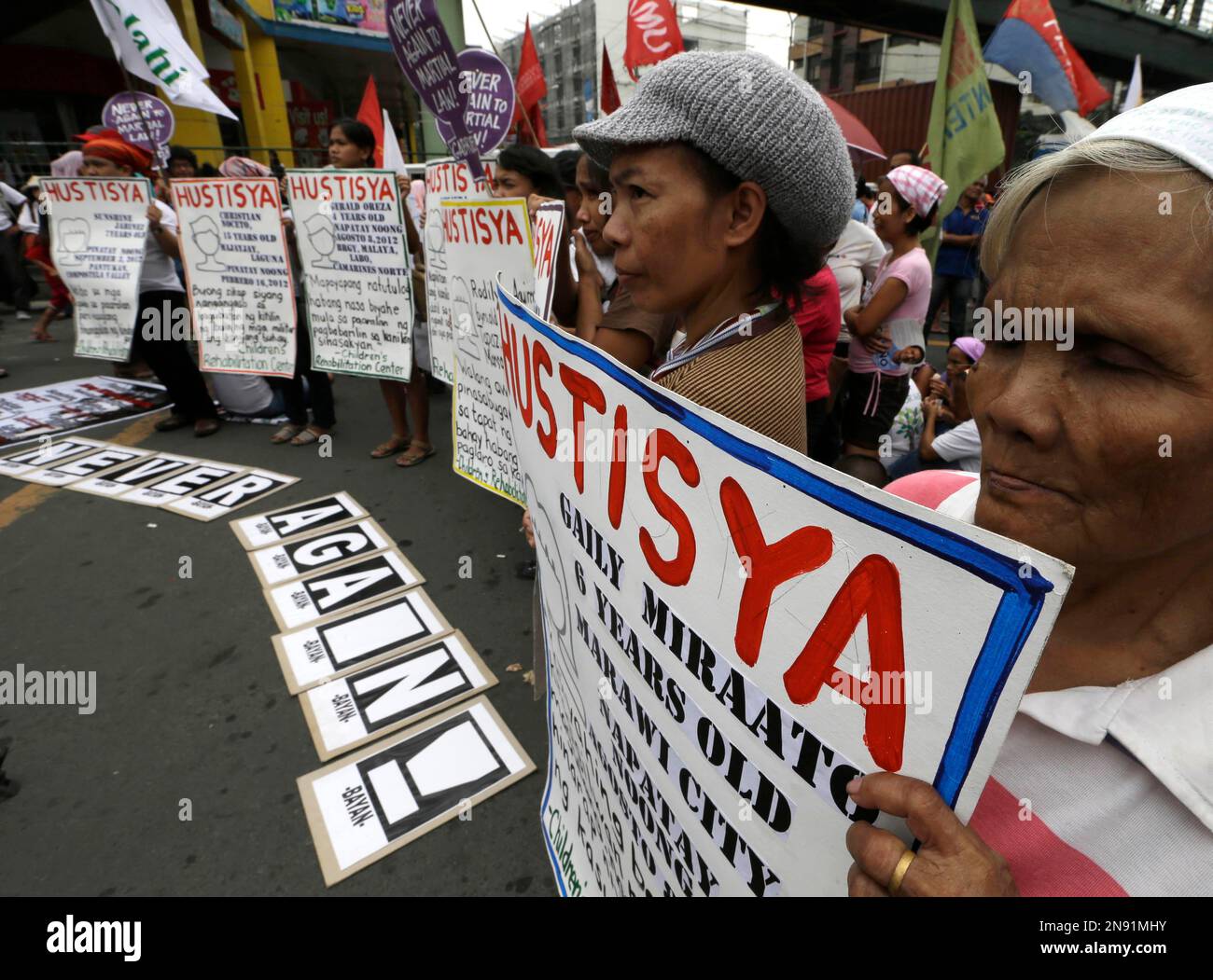 Protesters display placards as they gather at Mendiola Bridge leading ...