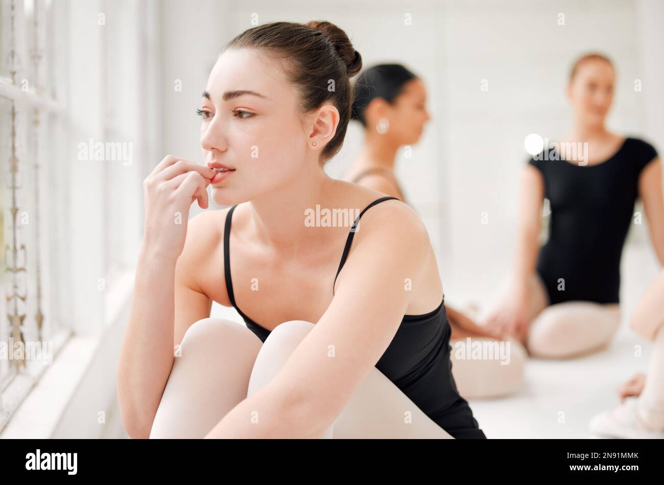 Restless heart, a promise land. a ballet dancer sitting away from the ...
