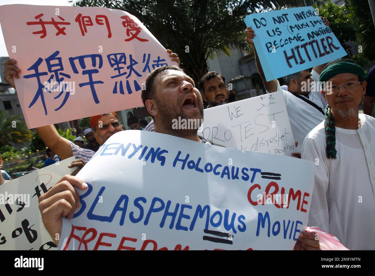 Muslim expatriates shout slogans in protest of a film ridiculing Islam ...