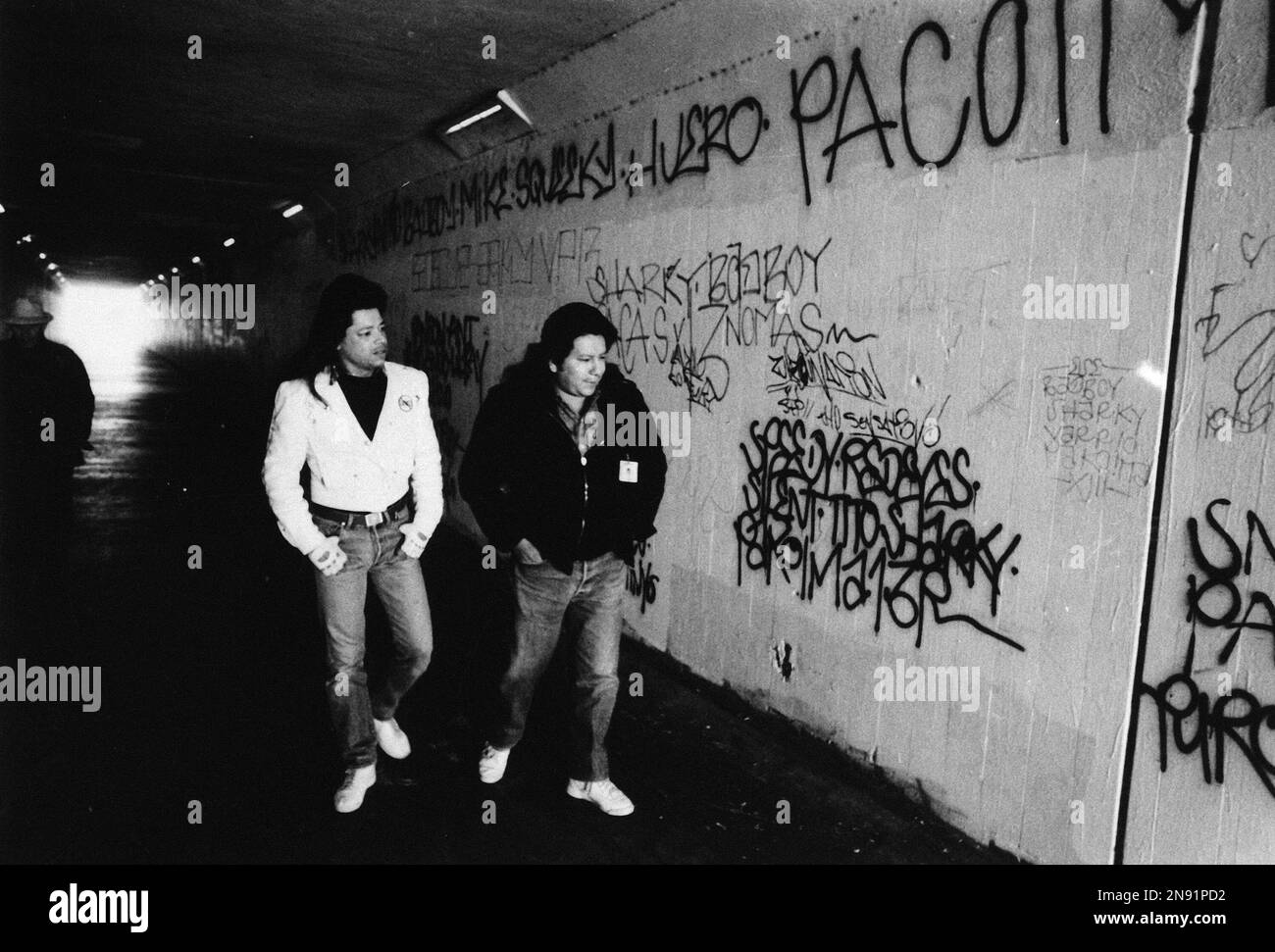 An unidentified member of the Diamond Street gang in Los Angeles walks ...
