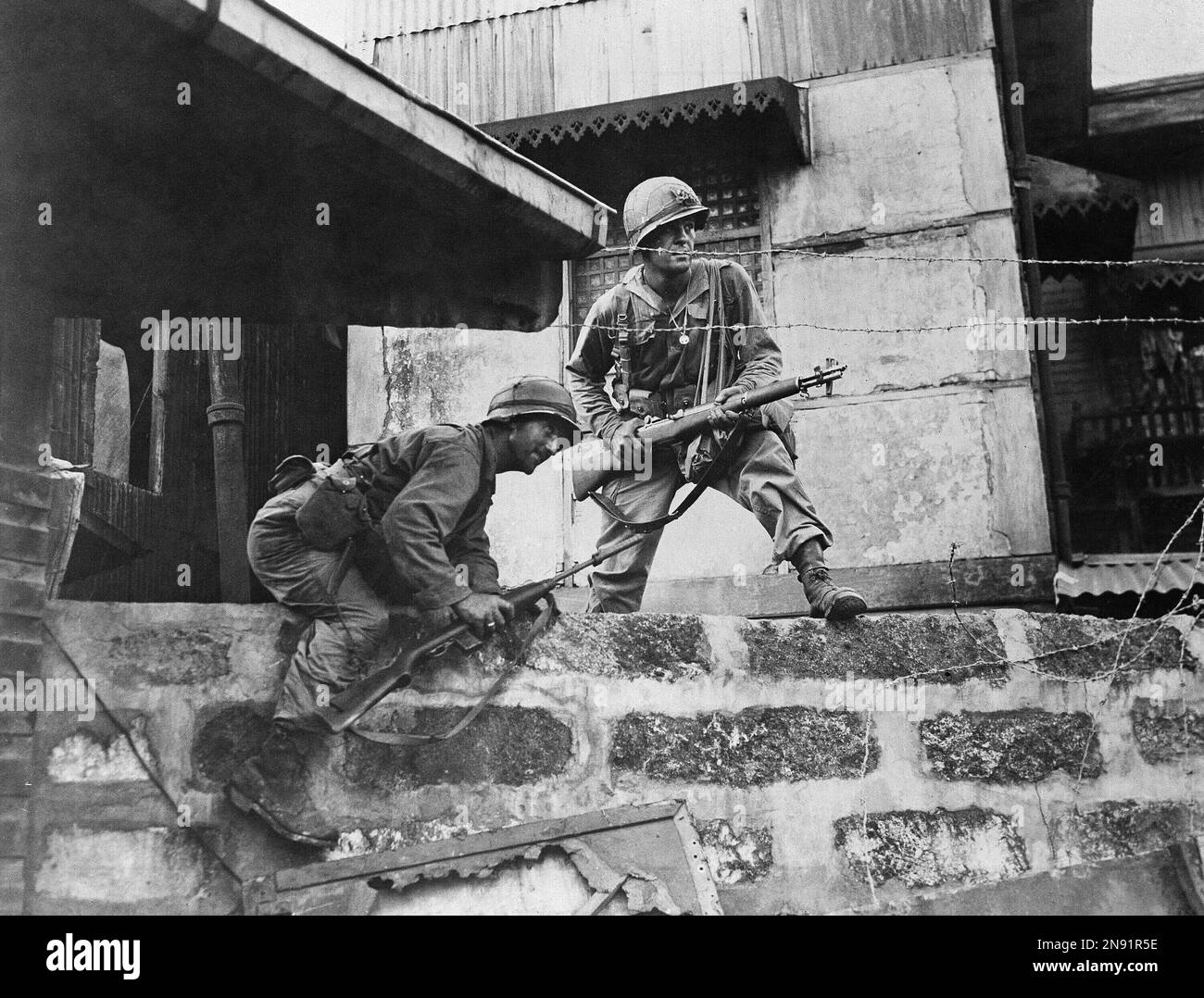 Two Yank infantrymen of the hard fighting 37th American division, climb ...