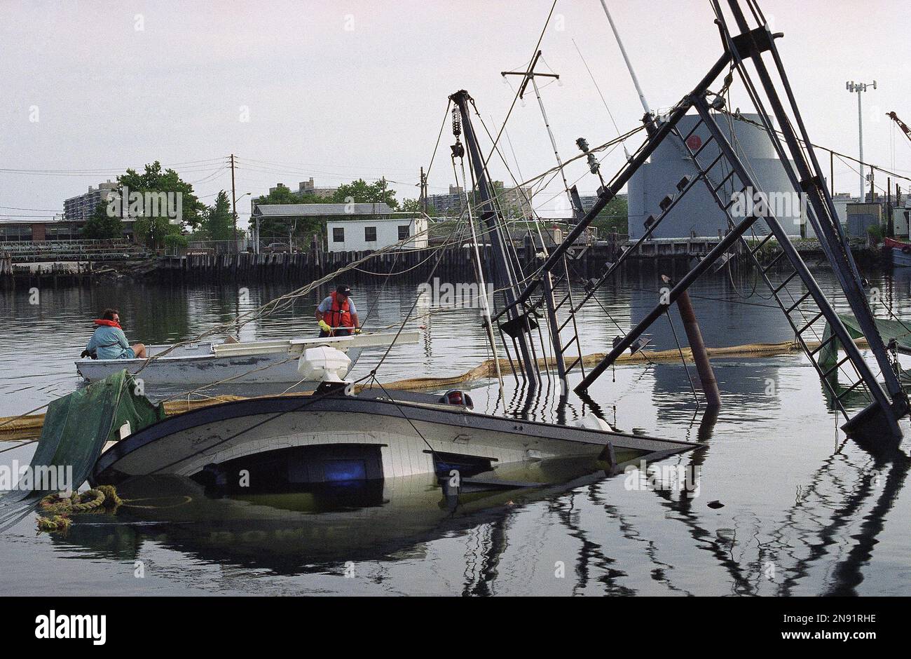 Rockaway Pollution Patrol officers check the oil containment boom ...