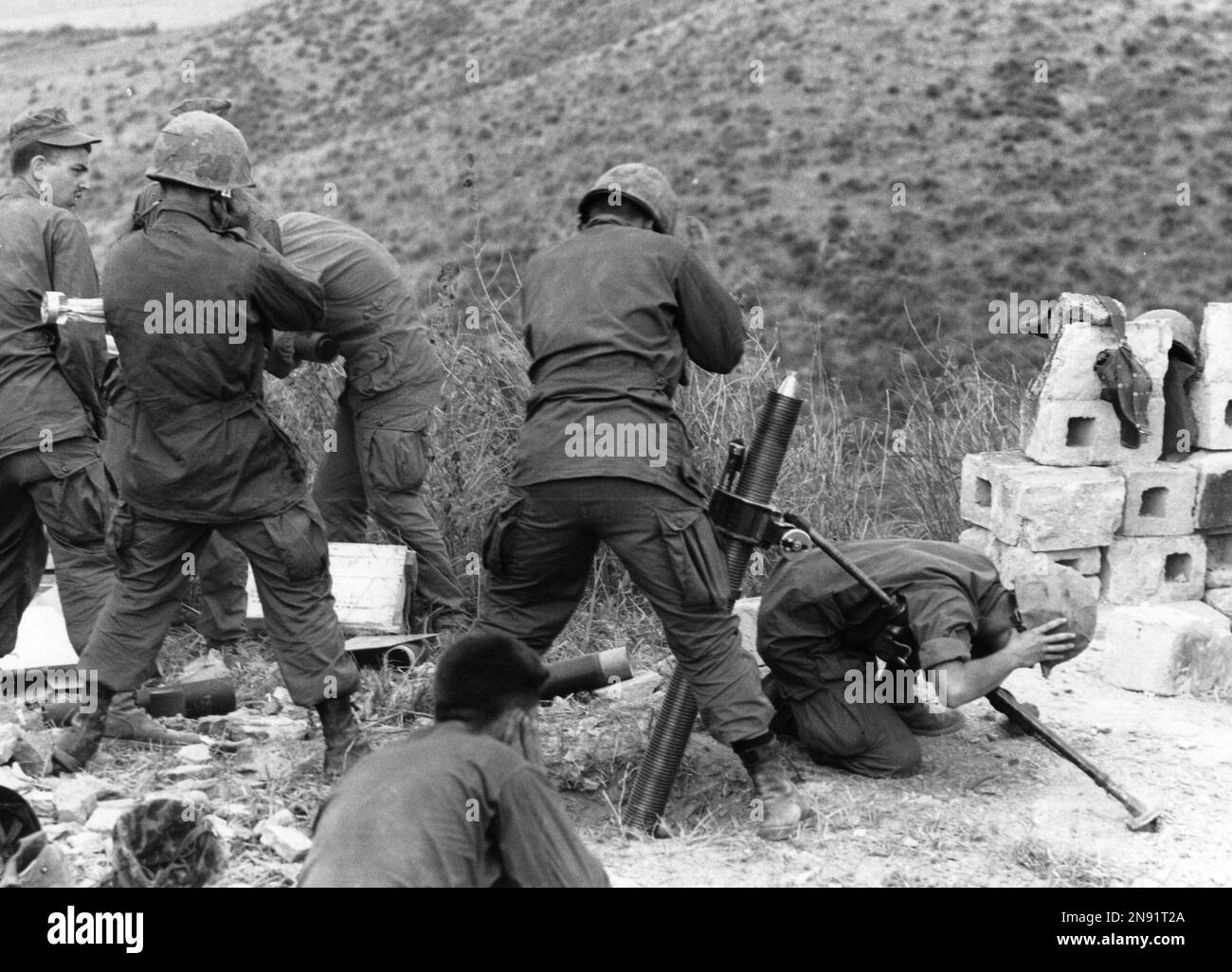U.S. Marines fire mortars at enemy positions during a patrol in newly ...