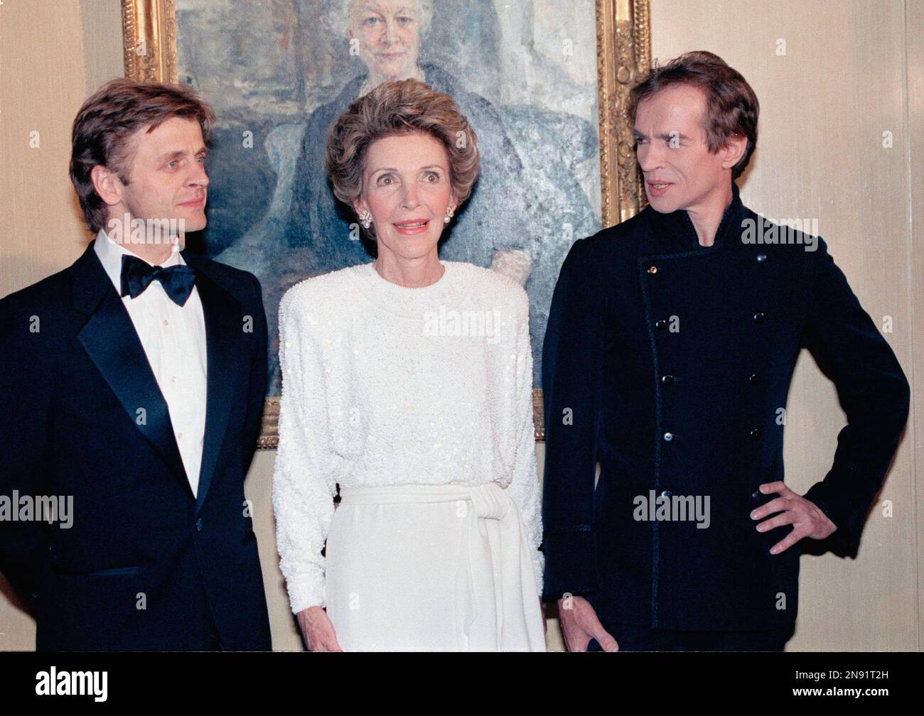 Flanked by dancers Mikhail Baryshnikov, left, and Rudolph Nureyev ...