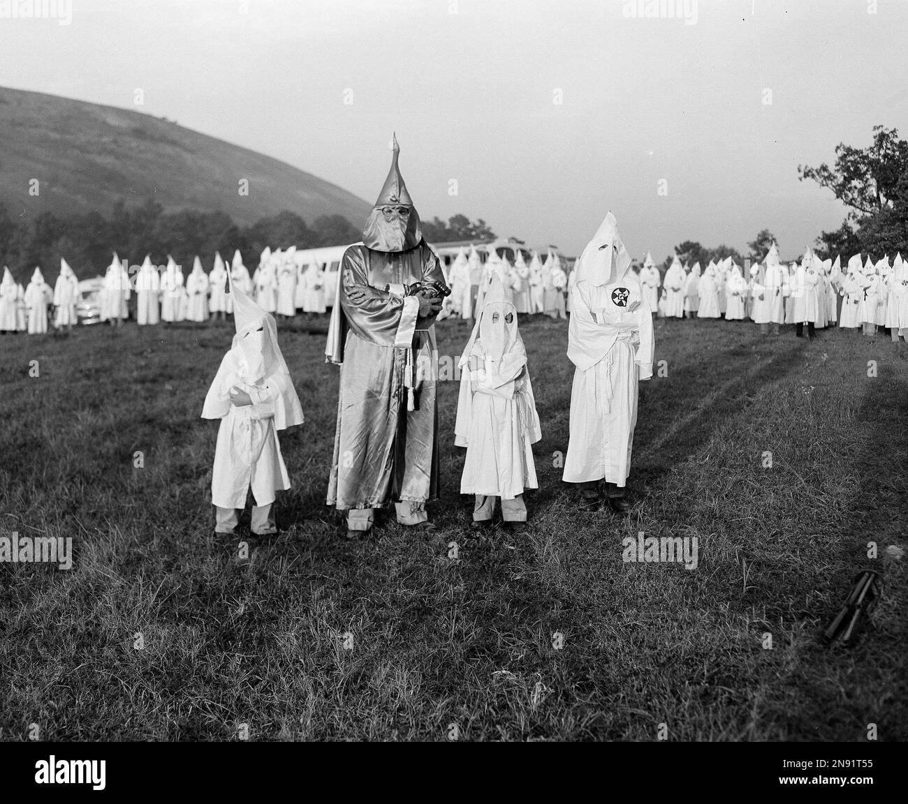 Two little mascots, equipped with their own robes and hoods, flank Dr ...