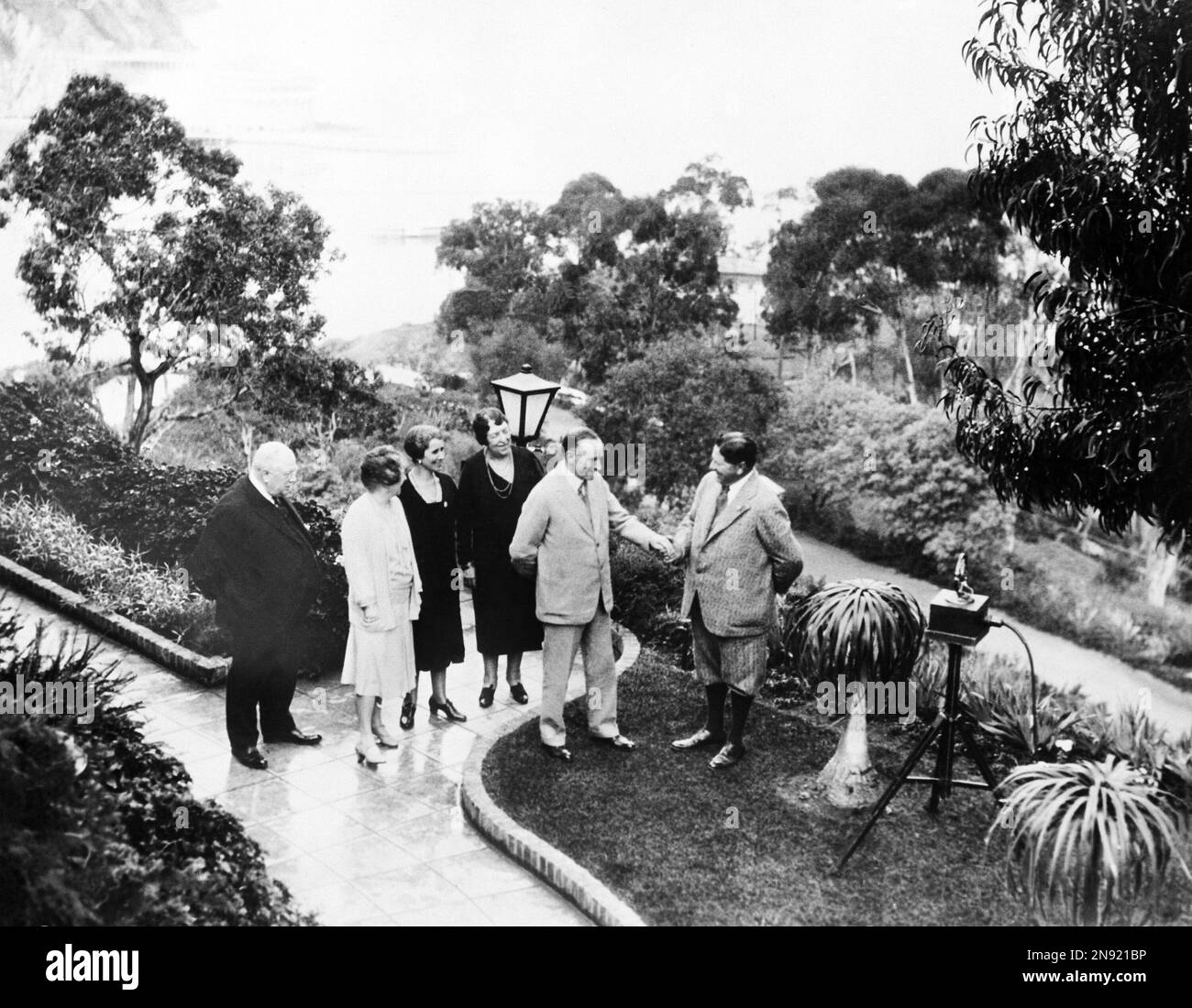 Pres. Calvin Coolidge and Mrs. Grace Coolidge are shown on the grounds ...