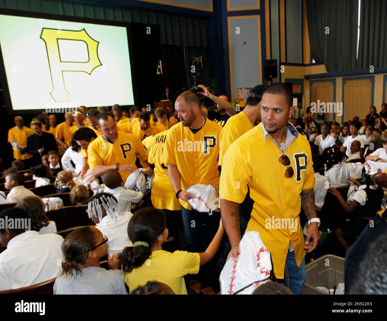 Pittsburgh Pirates right fielder Jose Tabata, right, hands out bags of ...