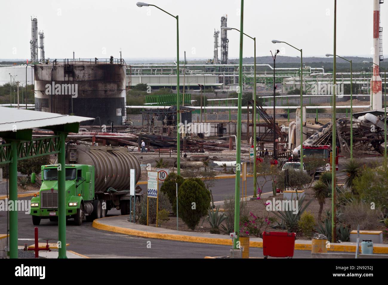 A truck leaves the badly damaged PEMEX facility after an explosion at a ...