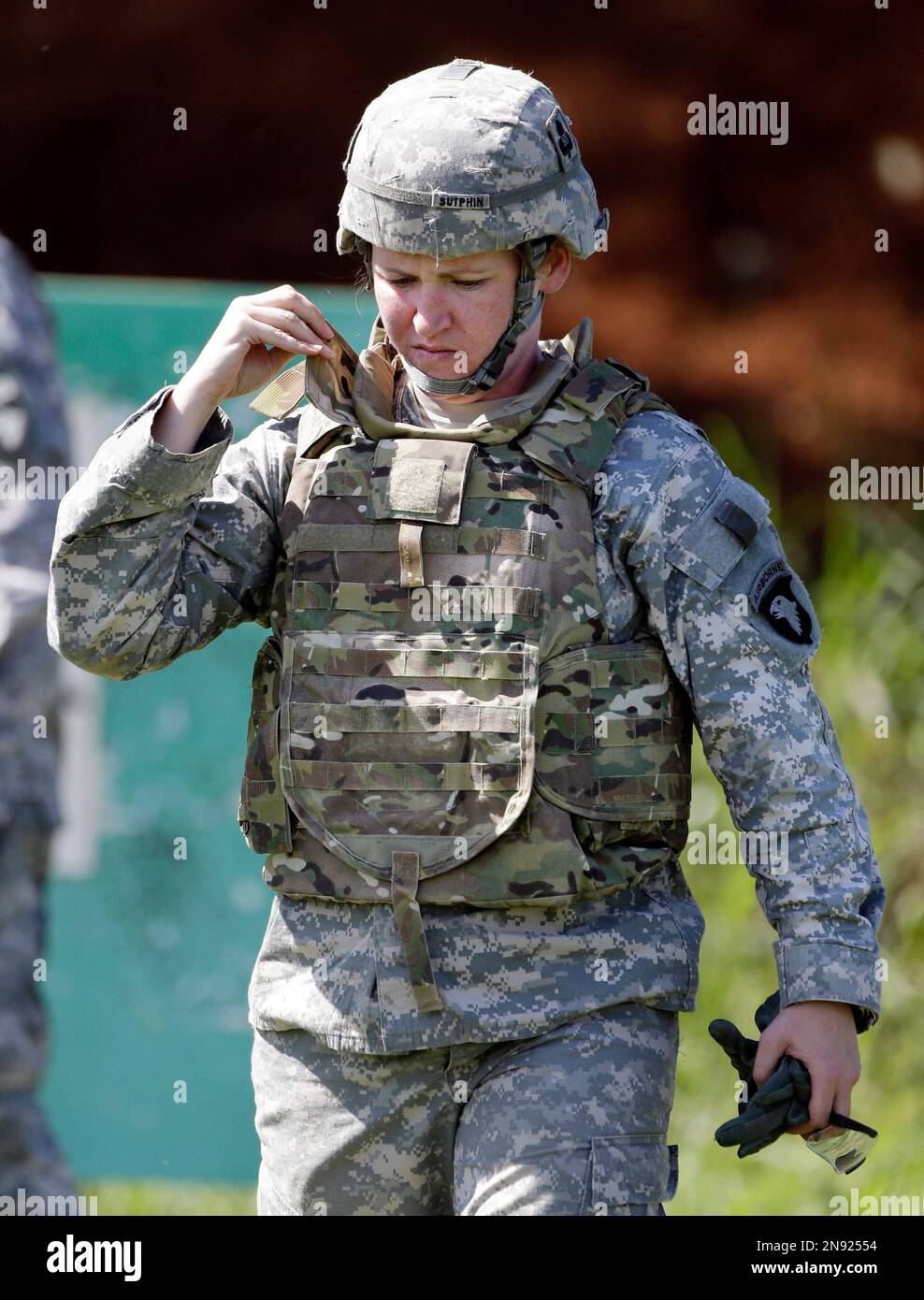 Spc. Sarah Sutphin adjusts her new body armor while training on a ...
