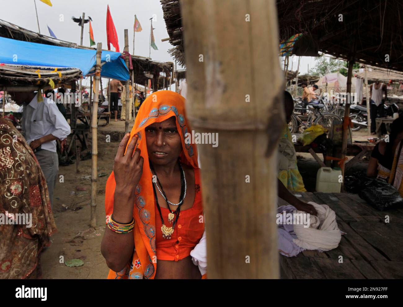 A Hindu devotee looks on, on the banks of the River Ganges in Allahabad ...