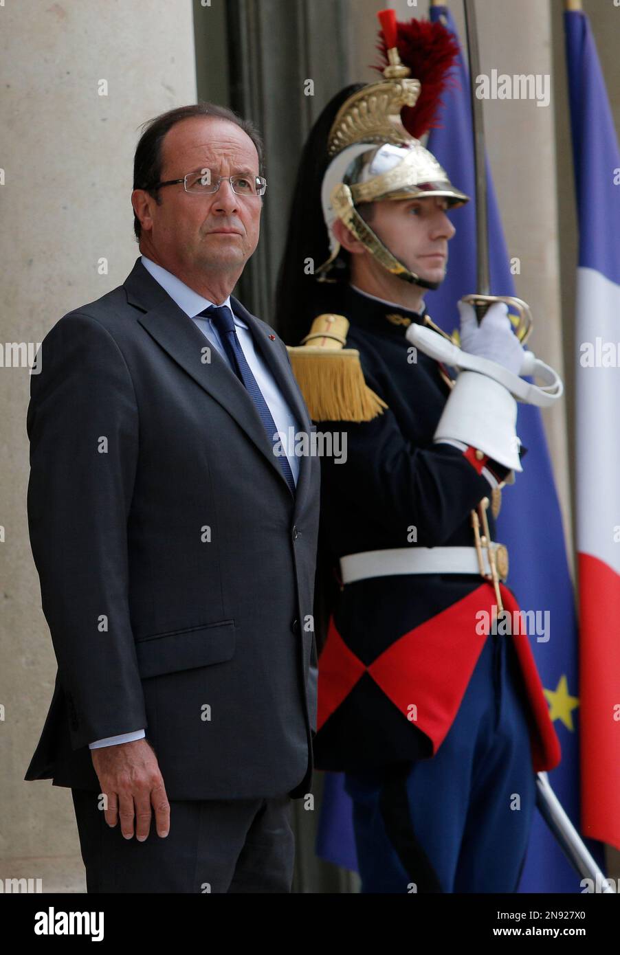 France's President Francois Hollande, left, waits for Burkina Faso ...