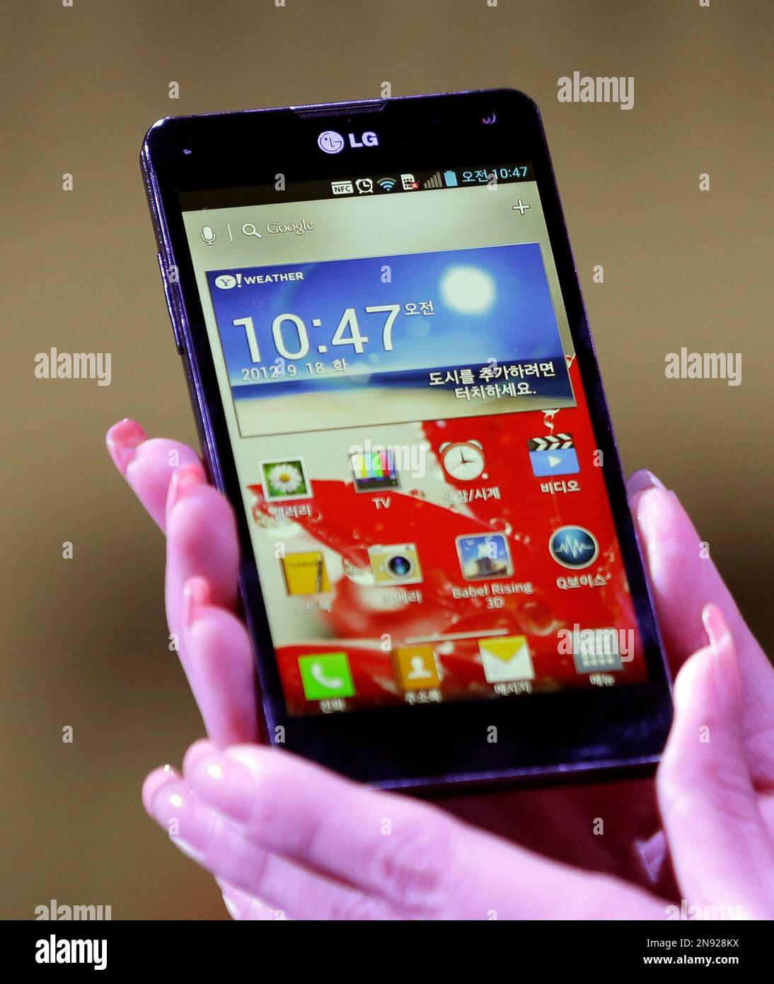 A model holds LG Electronics' new Optimus G smartphone during its ...