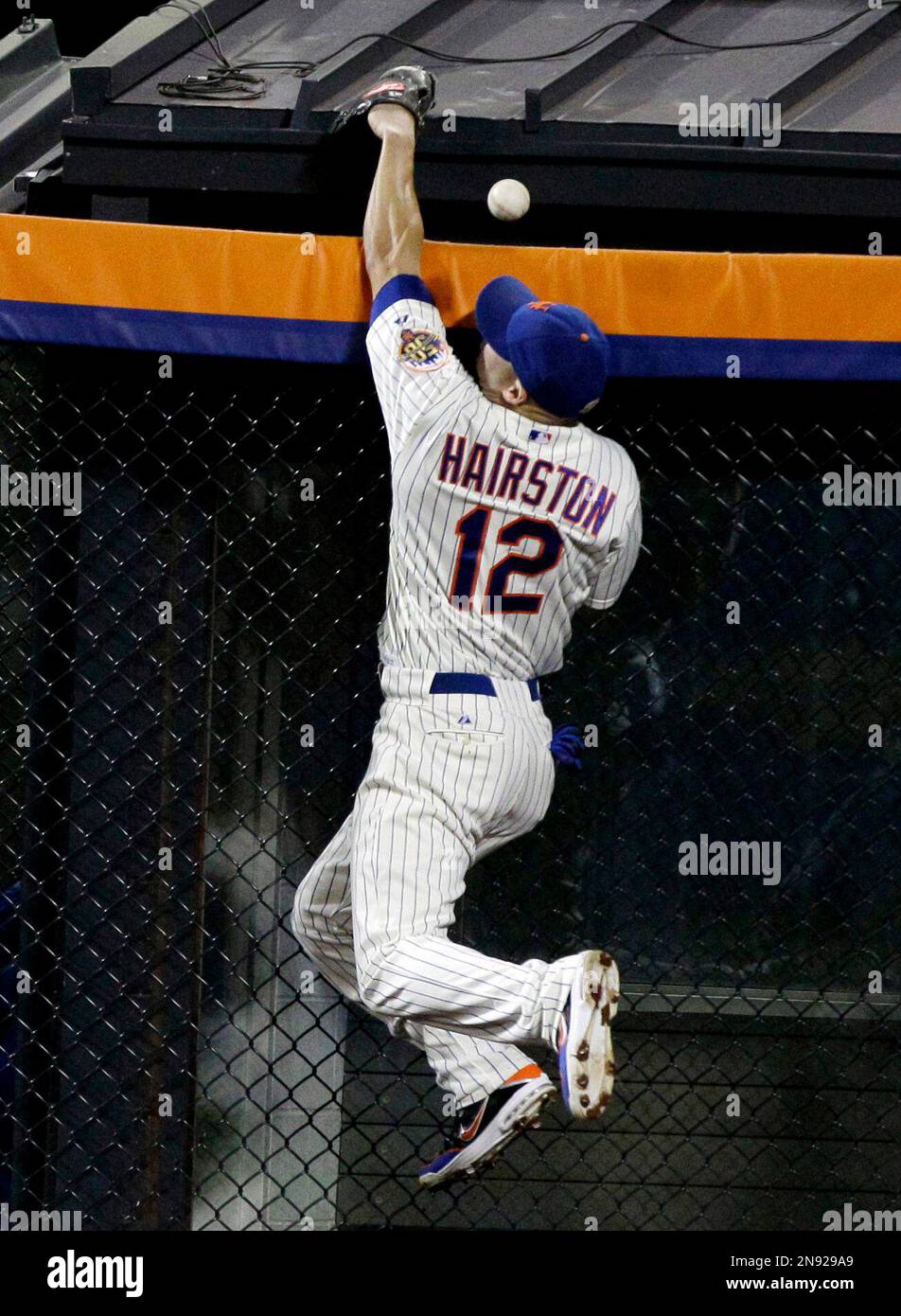 New York Mets right fielder Scott Hairston (12) leaps but can't reach ...