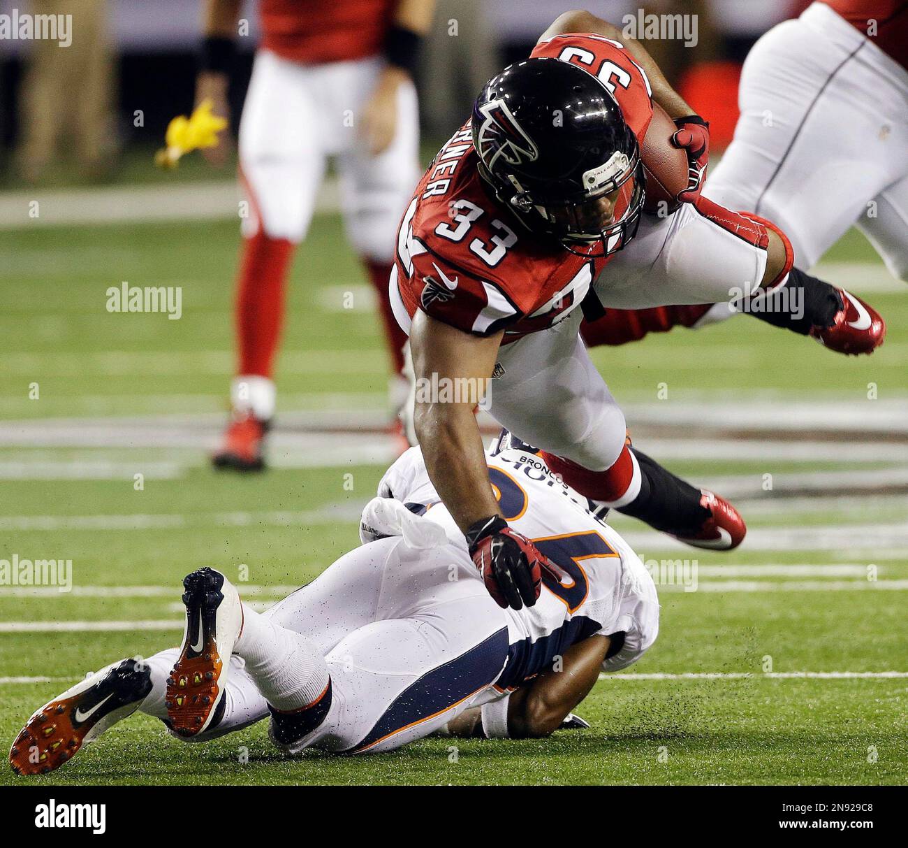 Atlanta Falcons running back Michael Turner (33) is hit by Denver ...
