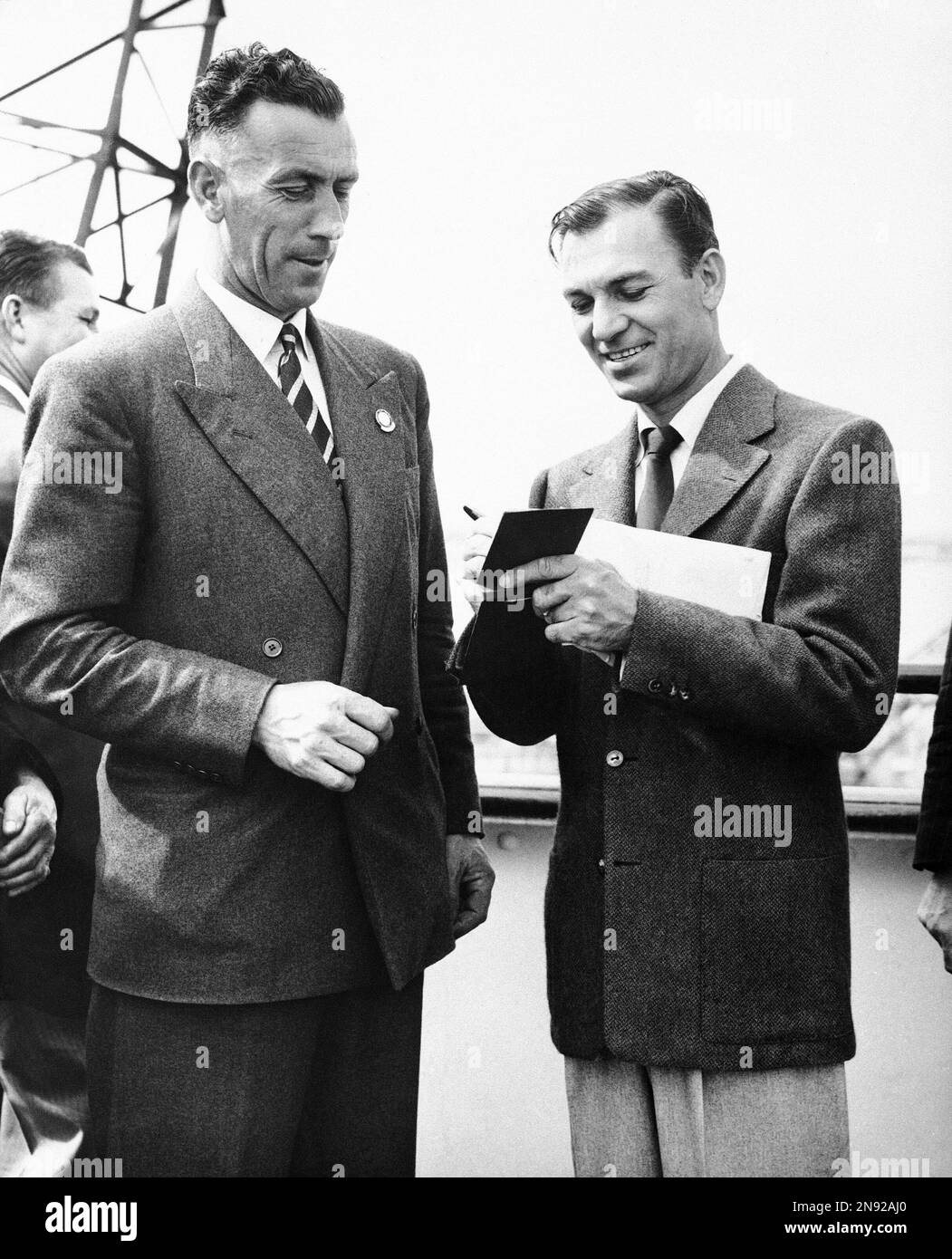 Ben Hogan, right, non-playing captain of the U.S. Ryder Cup team signs ...