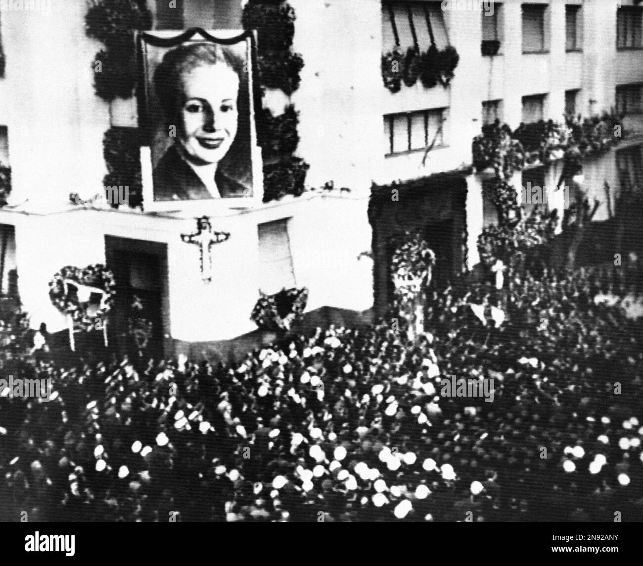 Following the funeral procession, the remains of Eva Peron are carried ...