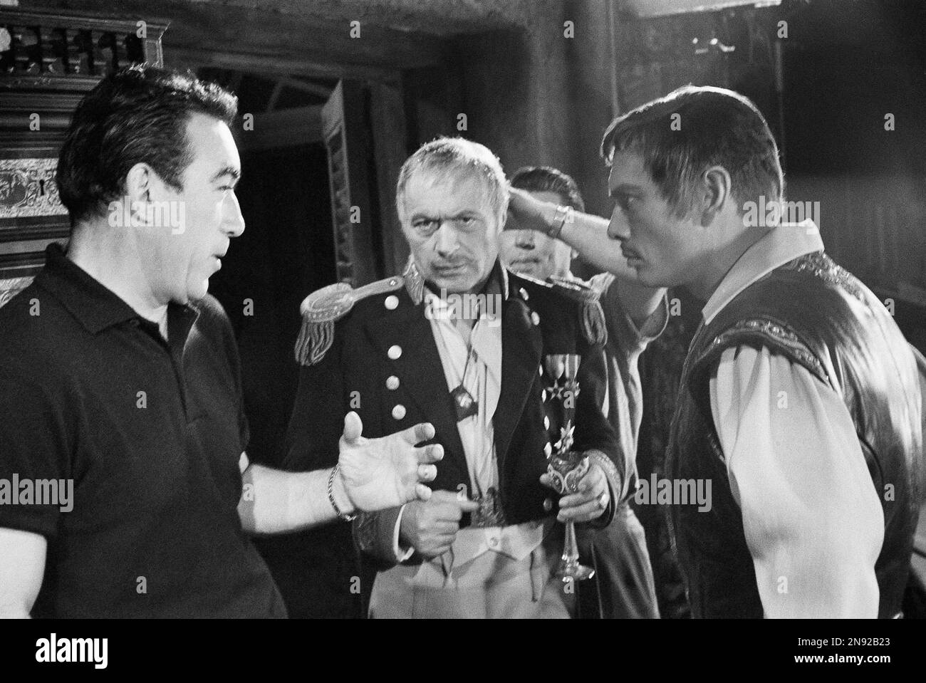 Anthony Quinn, left, directing his first picture, tells a pair of the ...