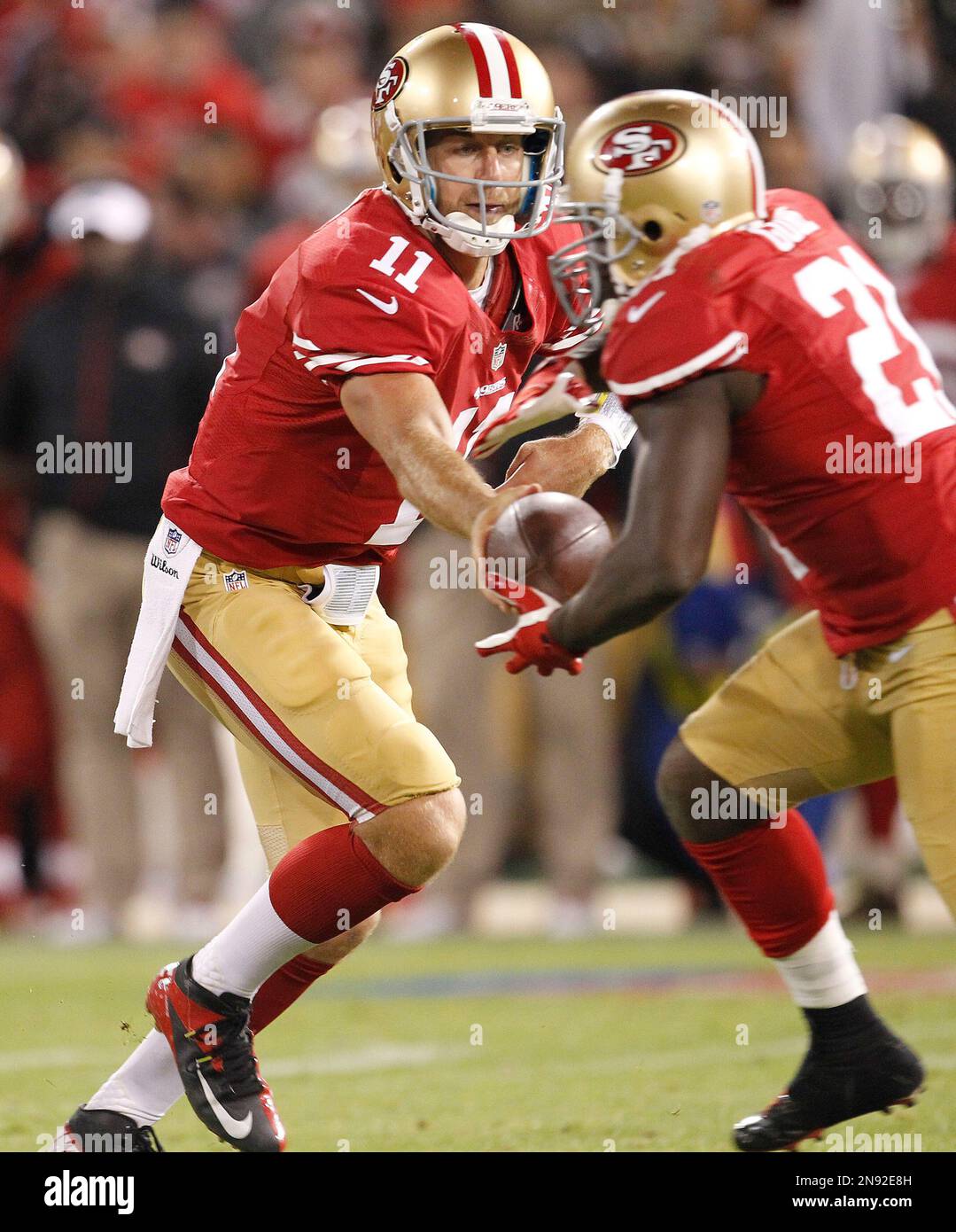San Francisco 49ers quarterback Alex Smith, left, hands off the ball to ...