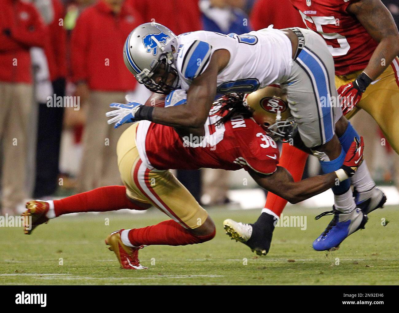 Detroit Lions running back Kevin Smith, top, is upended by San ...