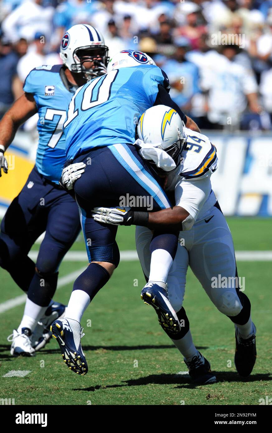 Tennessee Titans quarterback Jake Locker is hit by San Diego Chargers ...