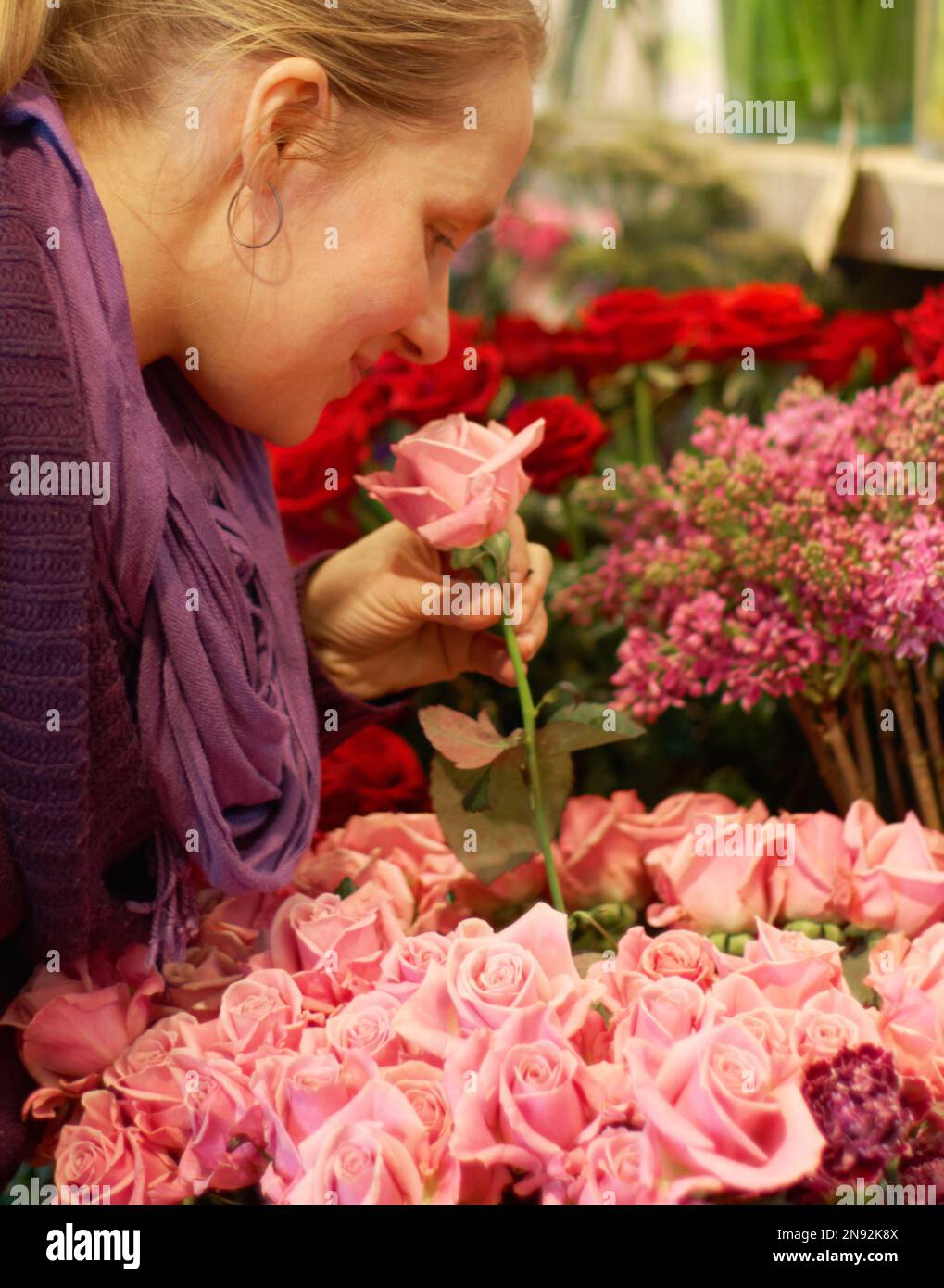 Woman, smelling roses and retail for floral bouquet for scent, color ...