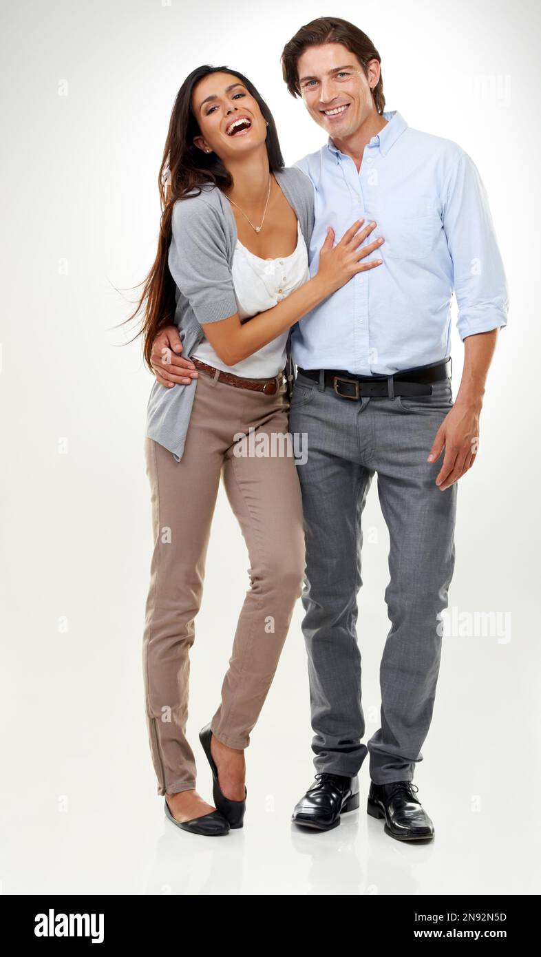 Couple laughing, woman and man hug portrait in a studio isolated with a happy smile and hug ...