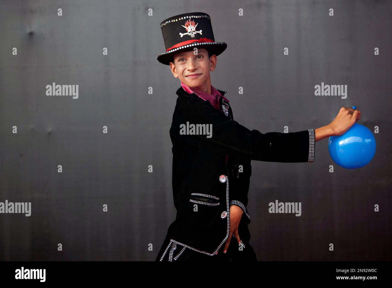 A magician performs with a balloon at the Magic Festival in New Delhi ...