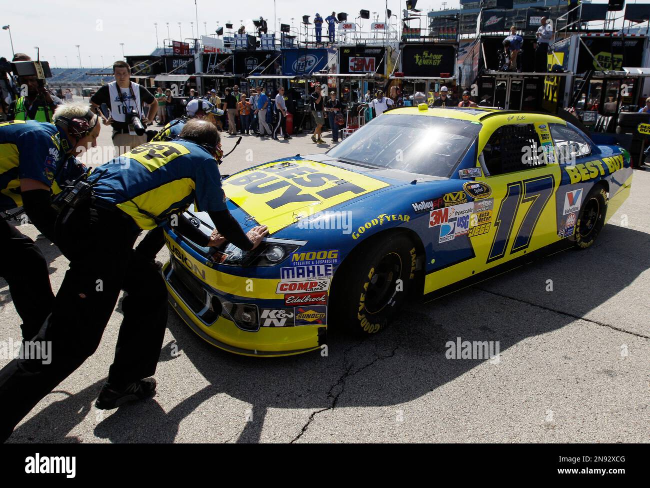 Crew members push Matt Kenseth's car during practice for the NASCAR ...