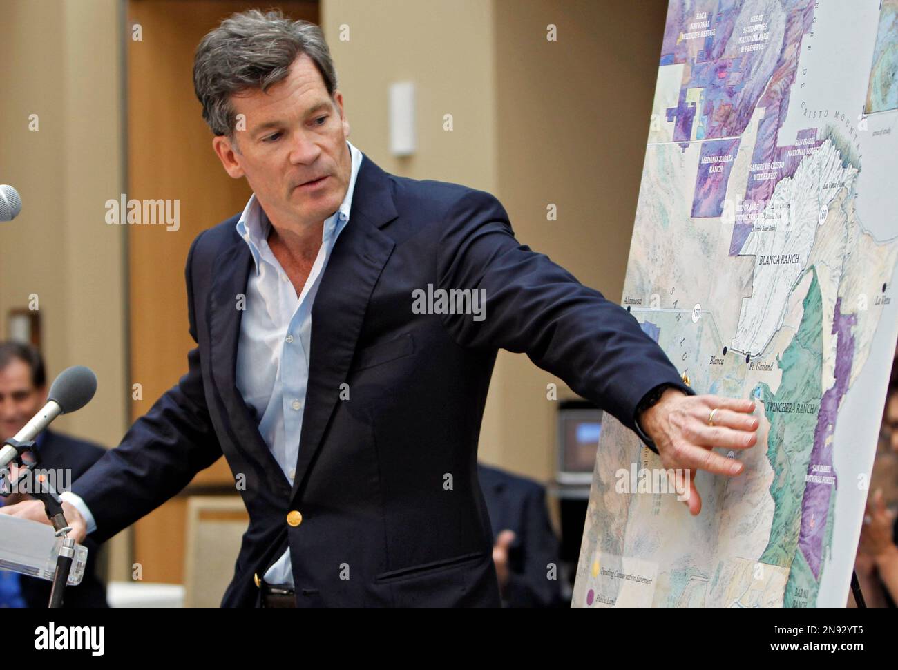 Billionaire hedge fund manager Louis Bacon uses a map to show his ranch ...
