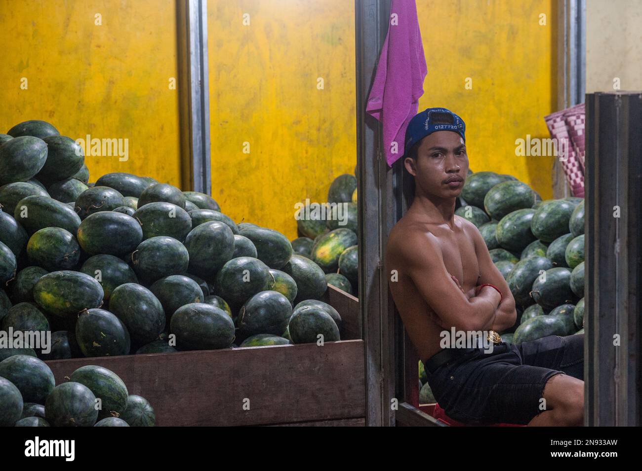 A young Cambodian man sells watermelons at the main wholesale vegetable ...