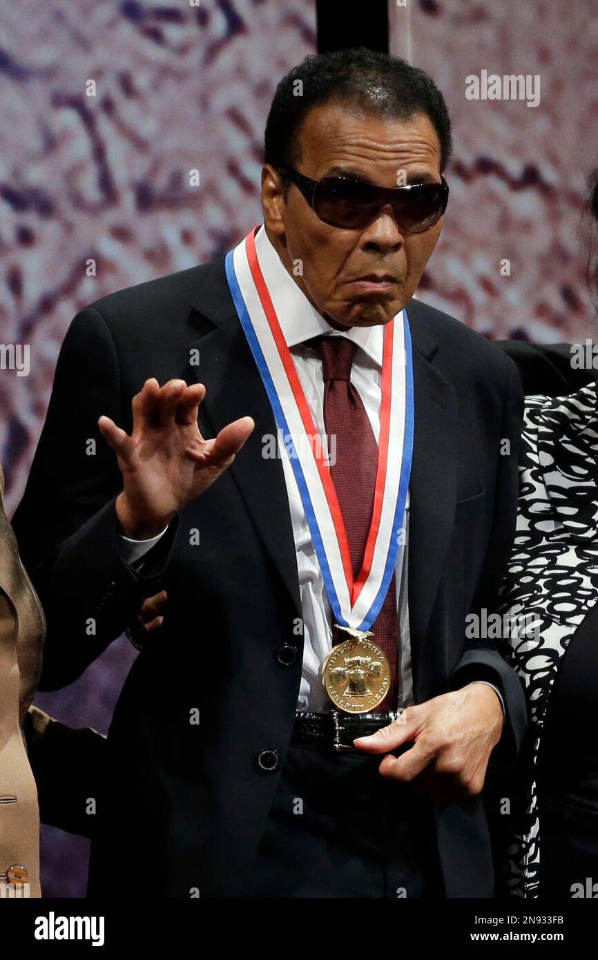Retired boxing champion Muhammad Ali waves after he received the ...