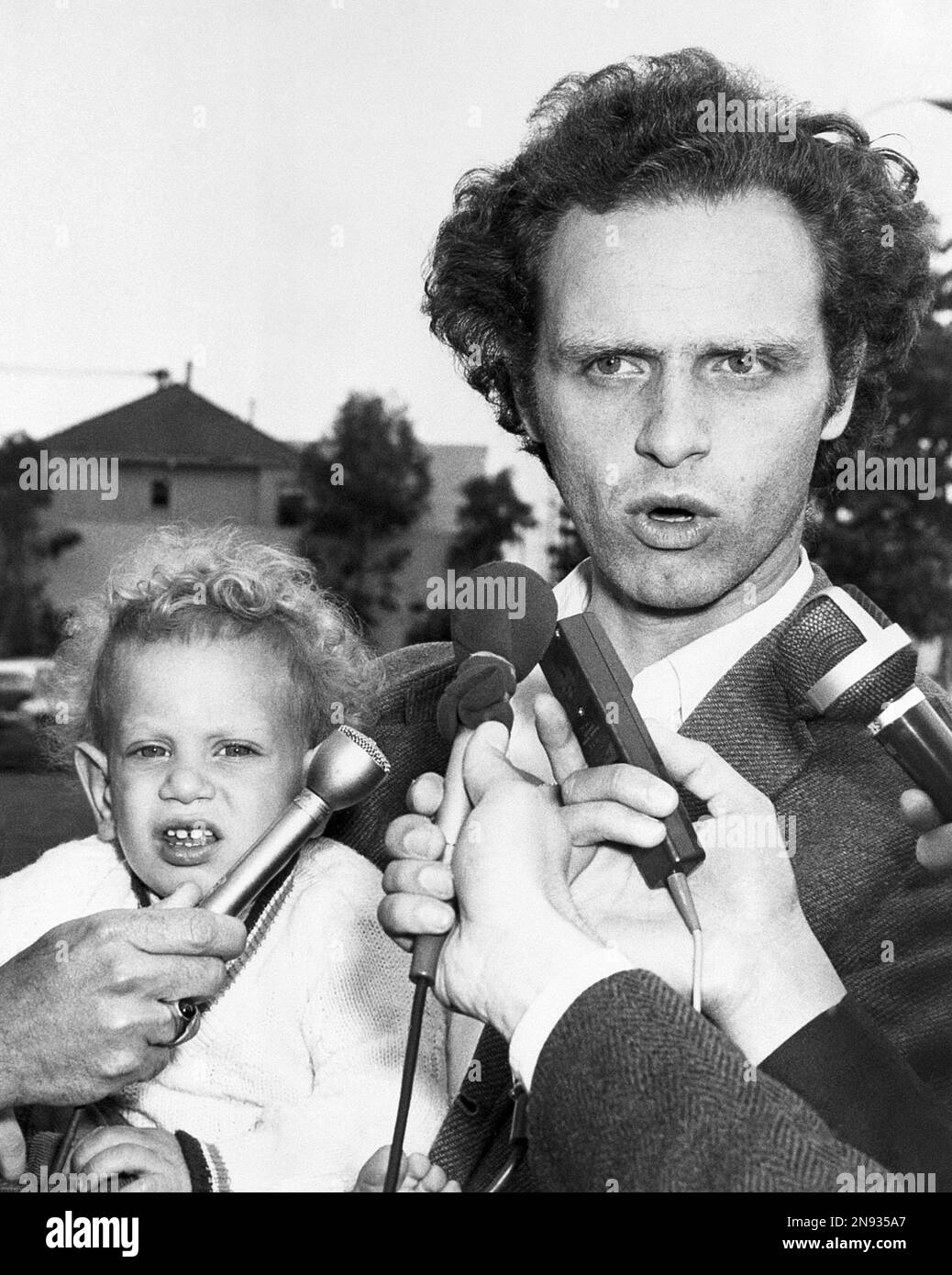Political activist Mario Savio, holding his son is interviewed in June ...