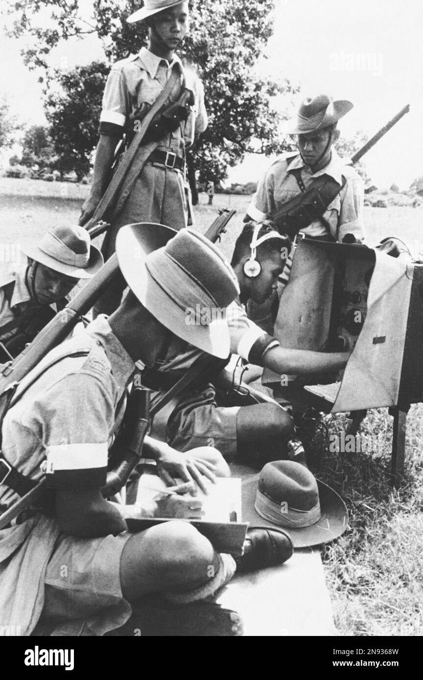 These soldiers of the Burma Rifles are working at a field radio set in ...